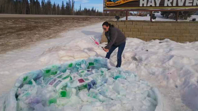 Hay River milk carton igloo melts (helped by baseball bat)